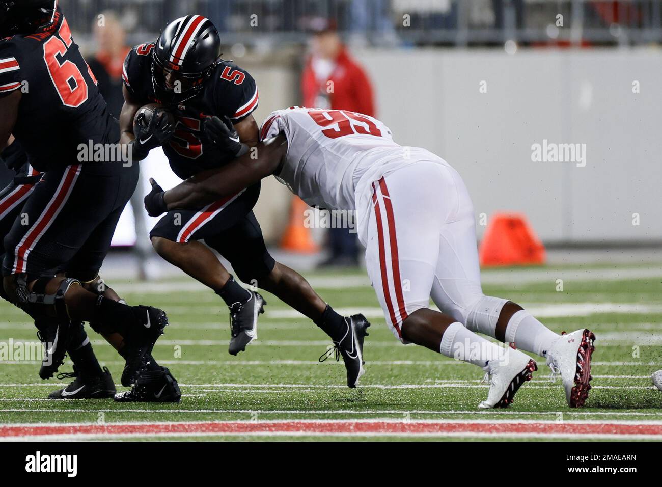Wisconsin defensive lineman Keeanu Benton, right, tackles Ohio State ...