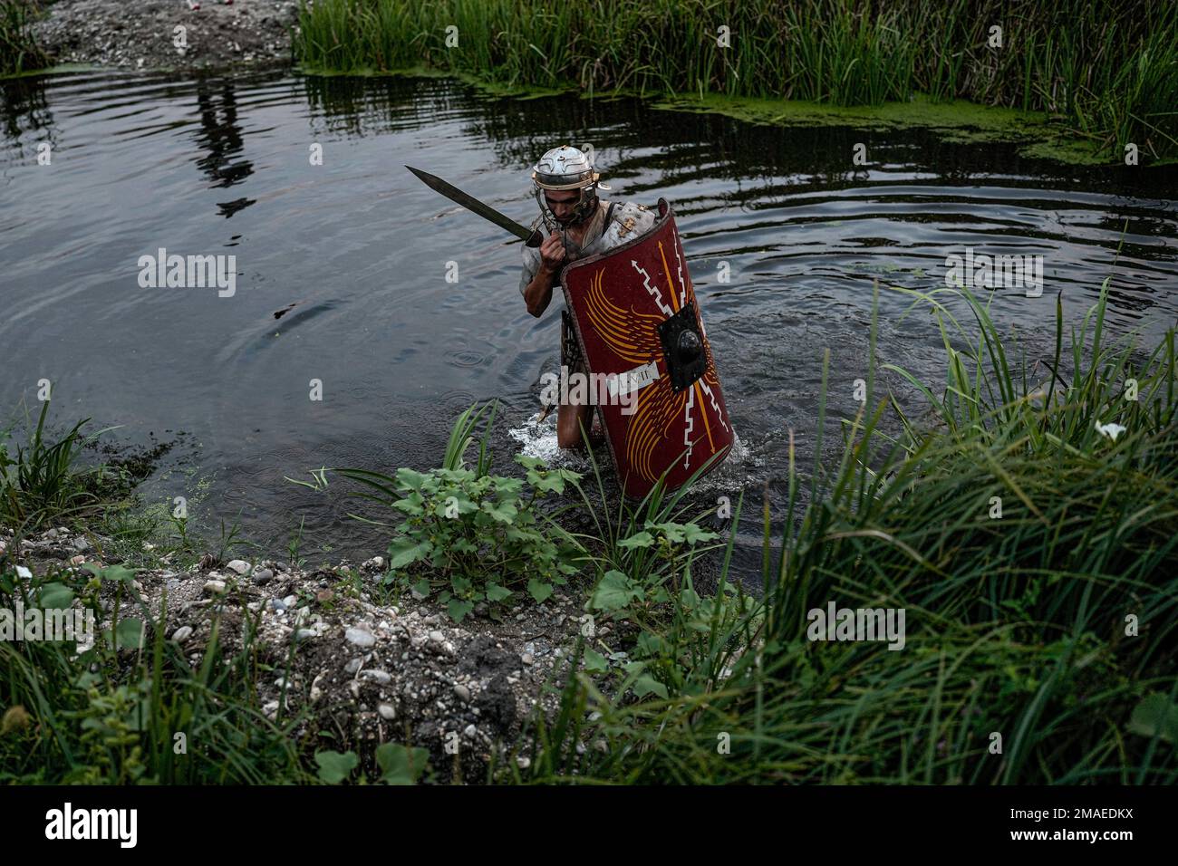 A man wearing a Roman soldier outfit walks after falling into a river ...