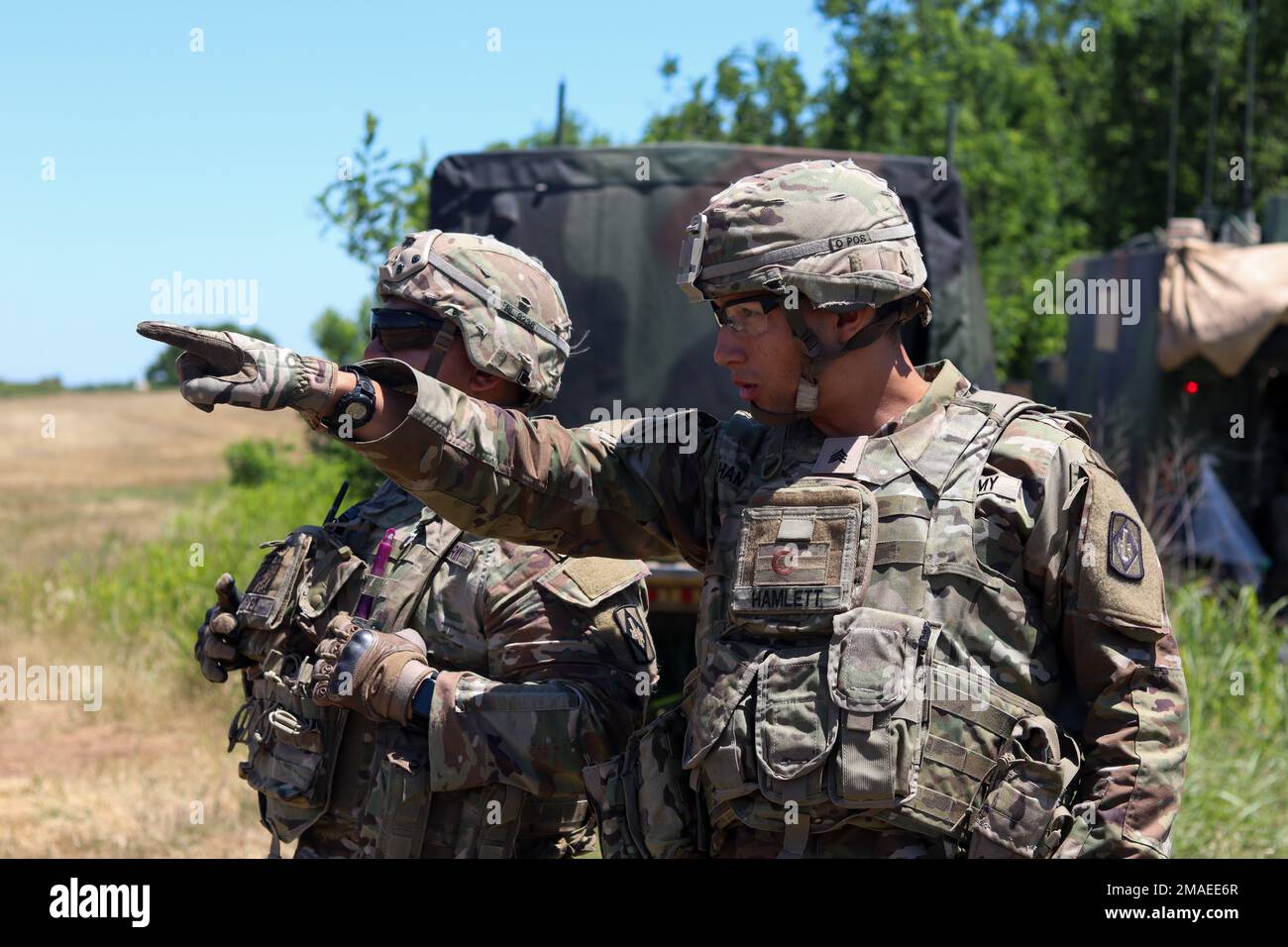 Soldiers prepare to fire M-270 Multiple Launch Rocket Systems May 26 during an air land raid ...