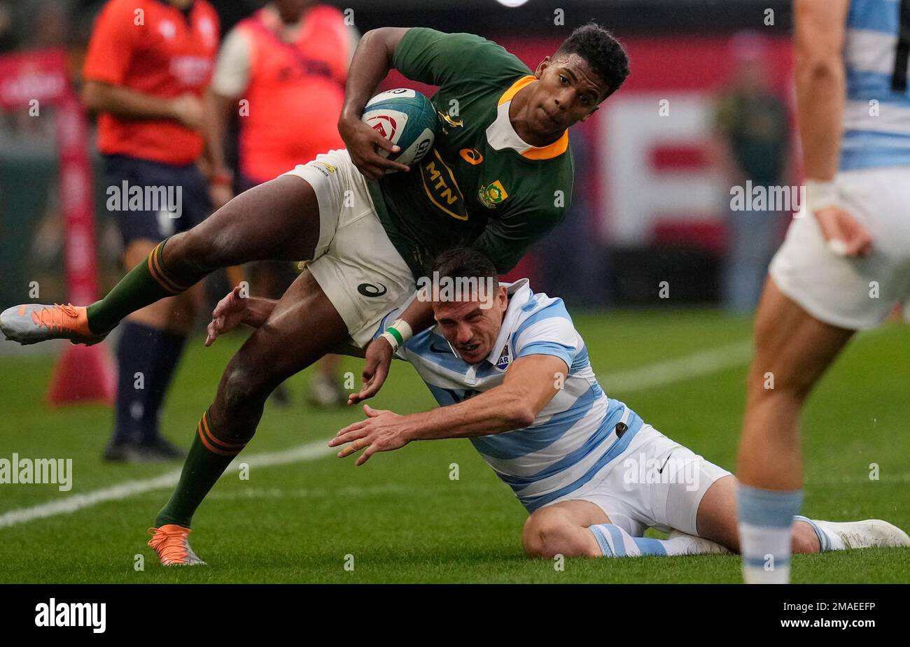 South Africa's Canan Moodie, left, avoids a tackle from Argentina's ...