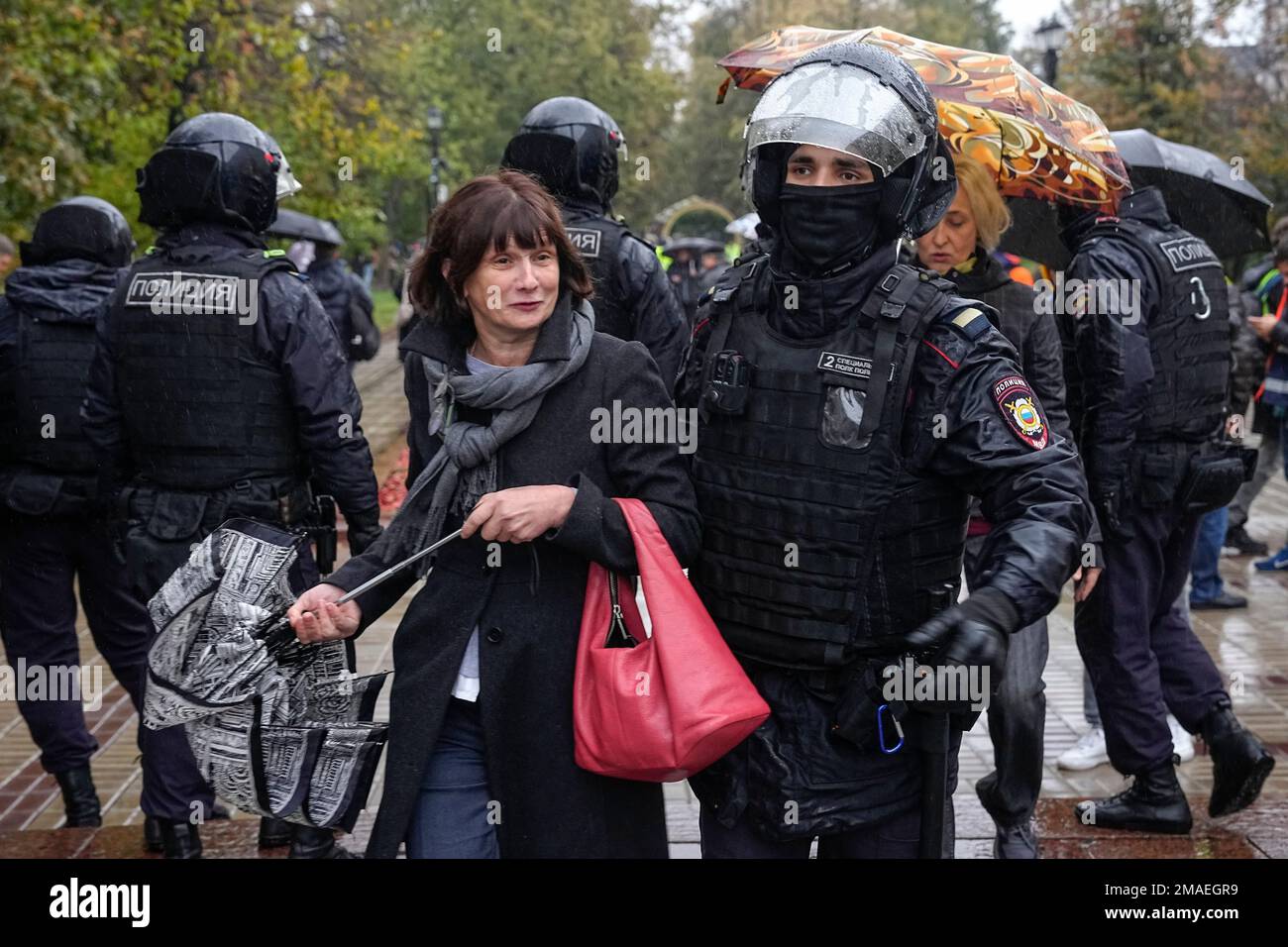 A Police officer detains a demonstrator during a protest against a ...