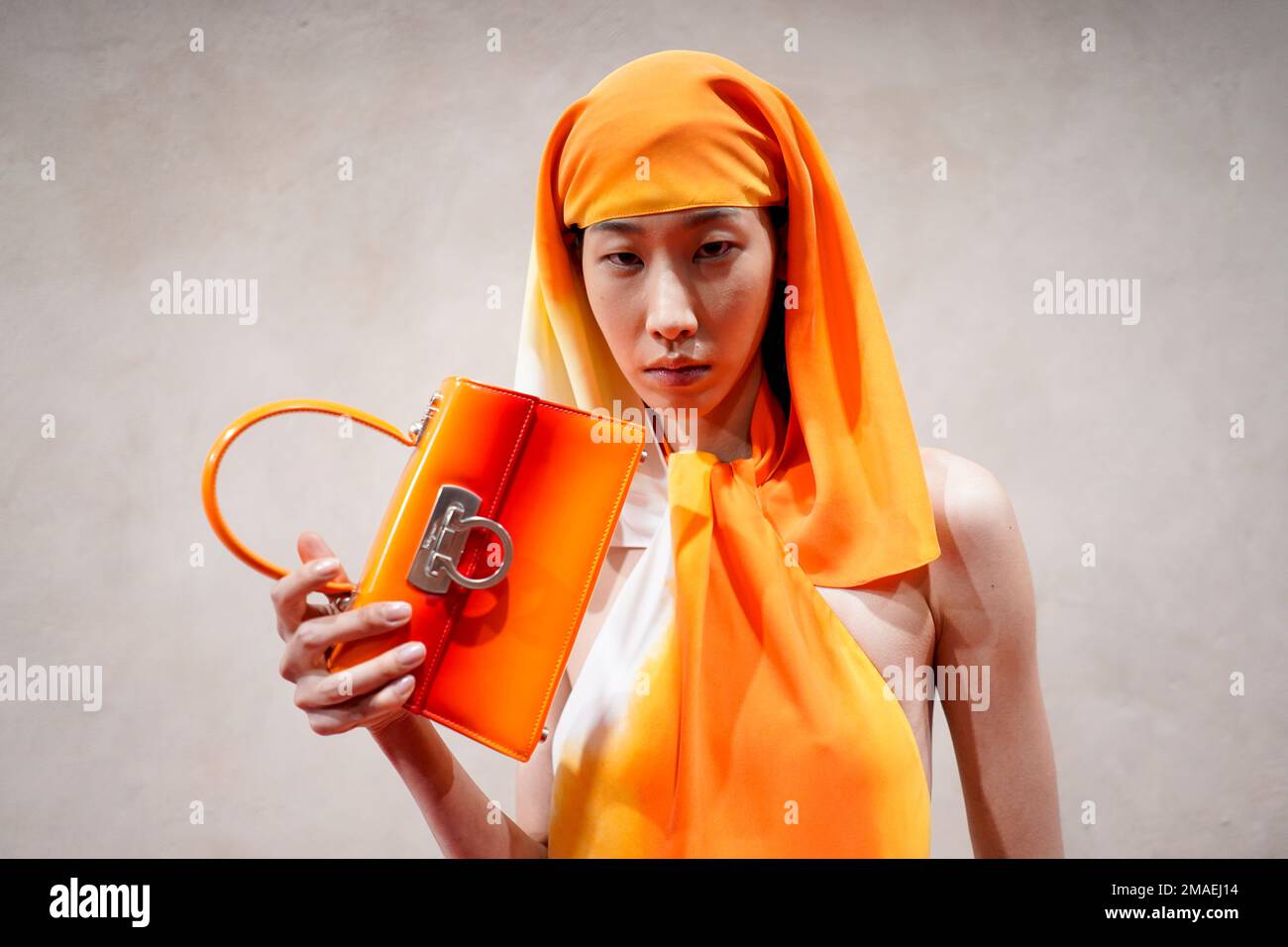 A model poses for a photographer backstage before the Ferragamo women's ...