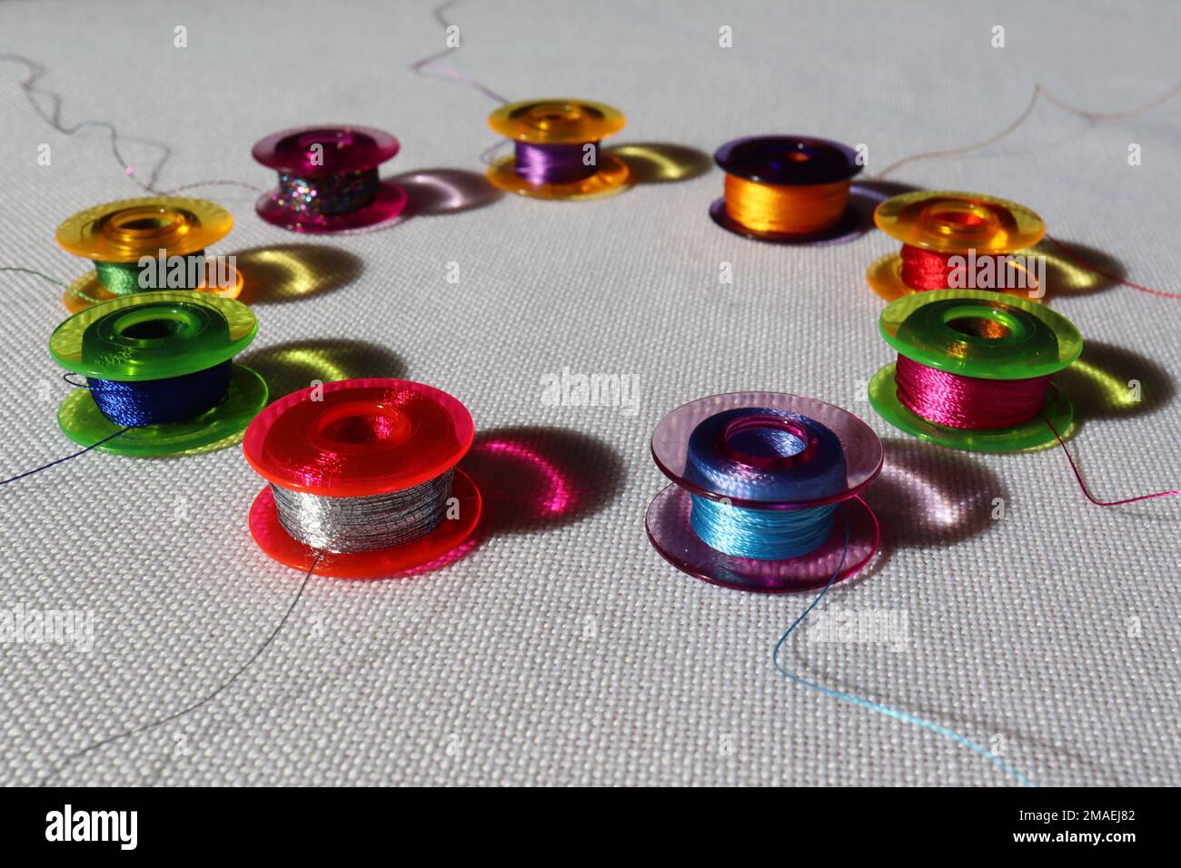 Close-up of a circle of nine multi-coloured yarns on multi-coloured ...