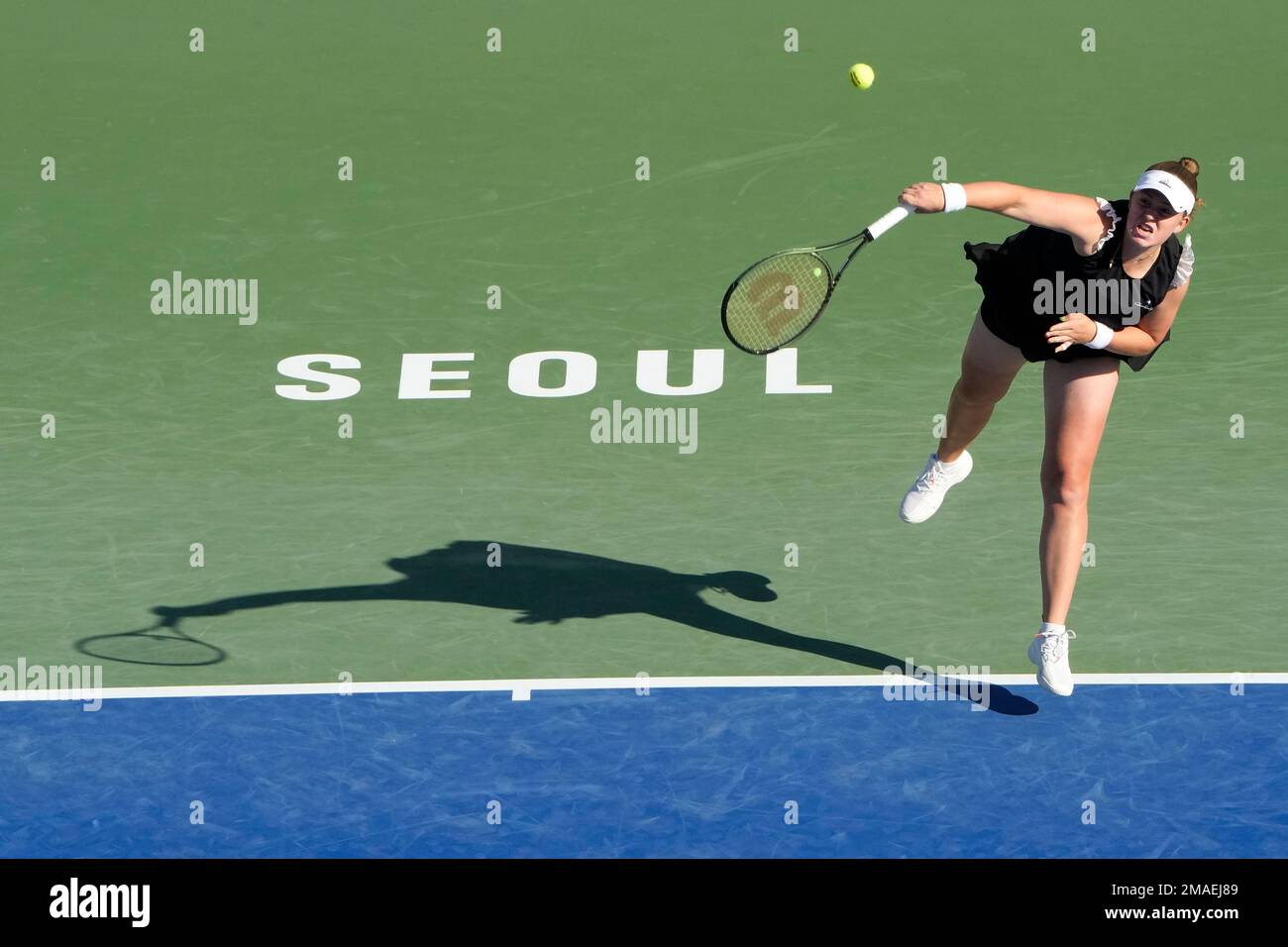 Jelena Ostapenko of Latvia serves to Emma Raducanu of Britain during ...