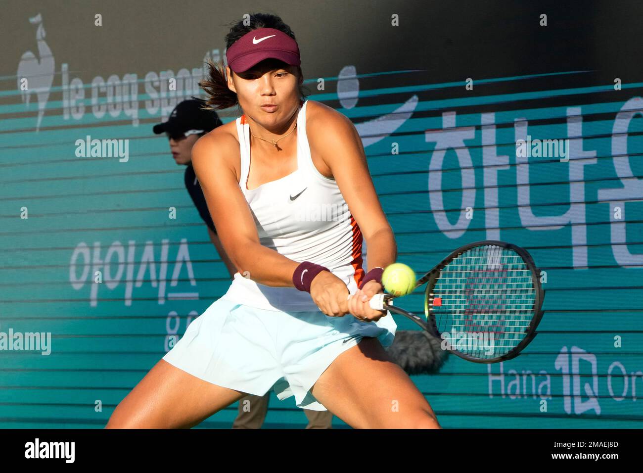 Emma Raducanu of Britain returns a shot to Jelena Ostapenko of Latvia ...