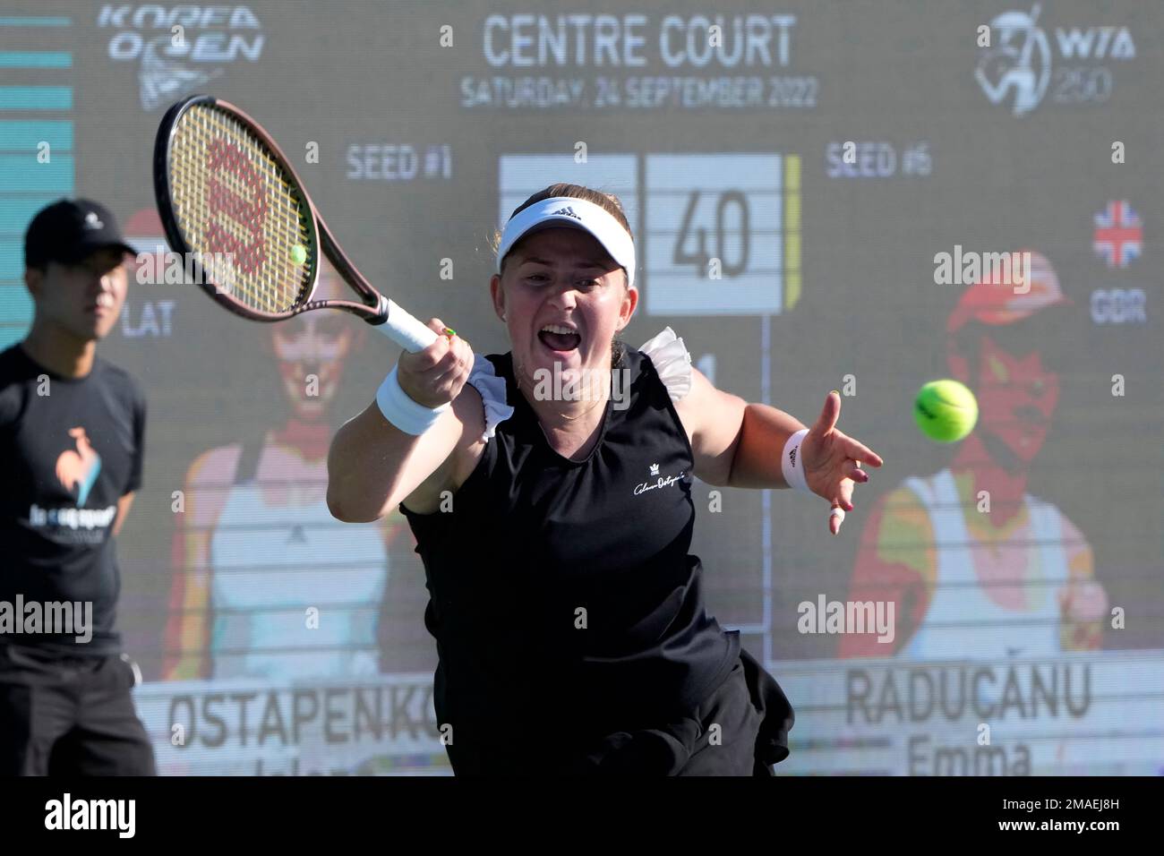 Jelena Ostapenko of Latvia returns a shot to Emma Raducanu of Britain ...