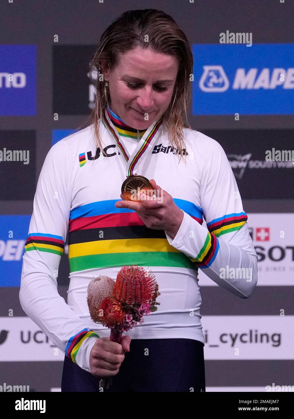 Annemiek van Vleuten of Netherlands looks at her gold medal after ...