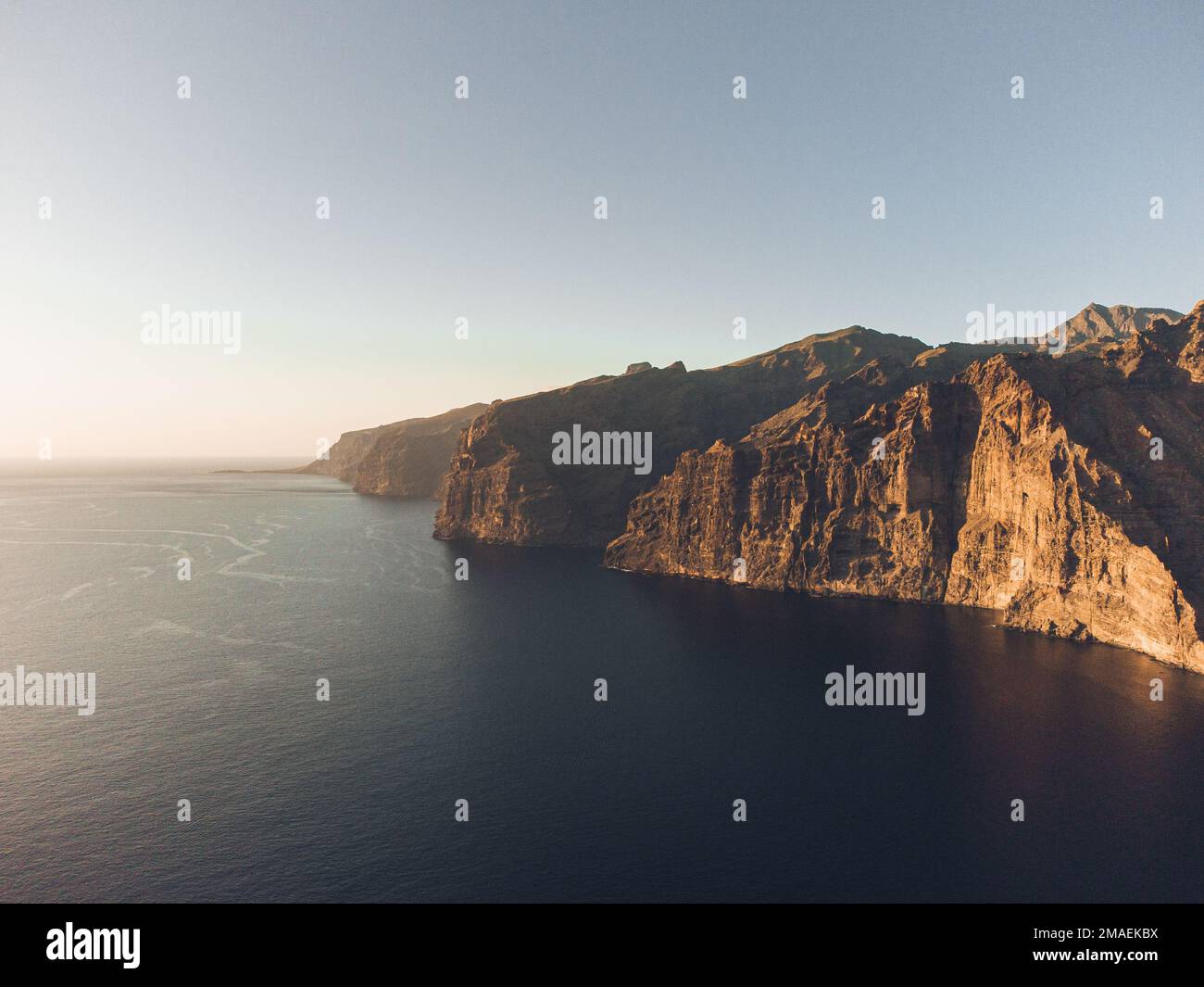 Aerial view of cliffs with ocean during sunset in Los Gigantes ...
