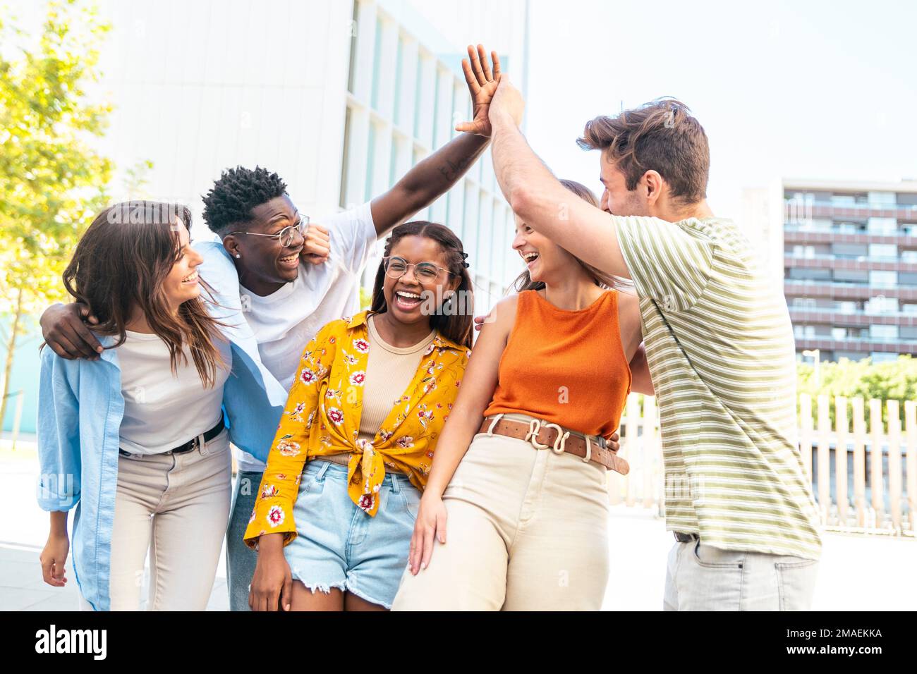 Group of happy multiracial friends having fun outdoors - Cheerful young ...