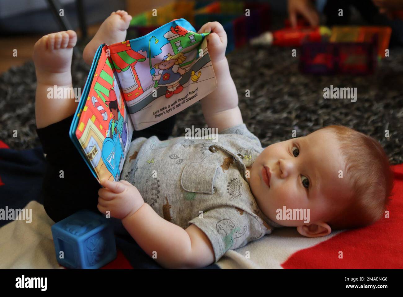 Six month old Evan Huelfer shows off his reading skills as he gets ...