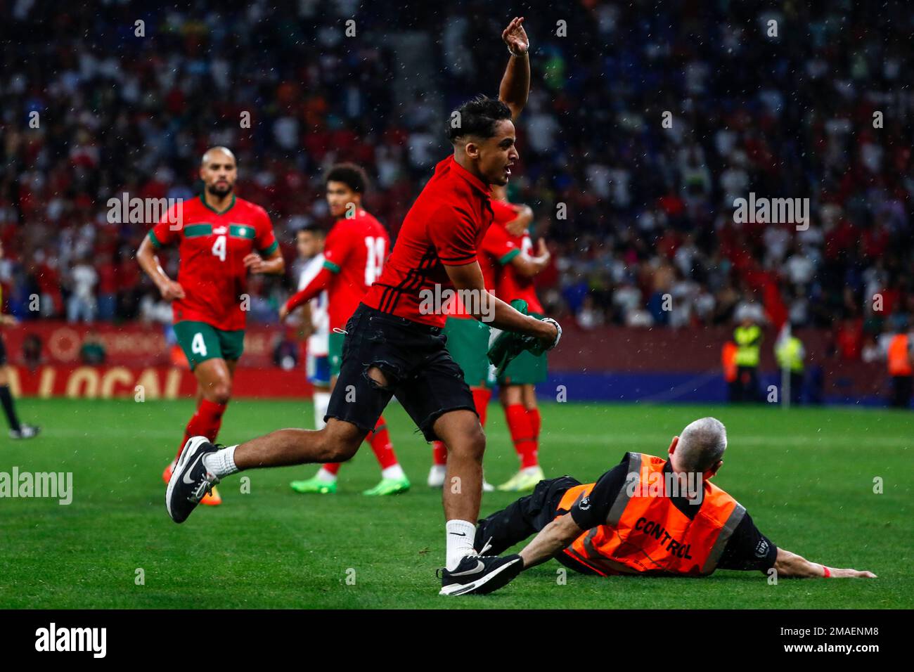 A pitch invader interrupts the game during an international friendly ...