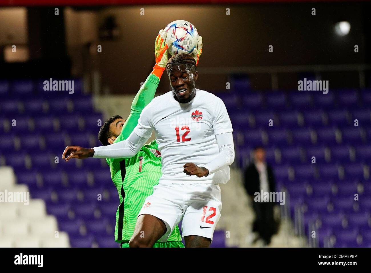 Qatar's goalkeeper Saad Al Sheeb, saves the ball behind Canada's Ike ...