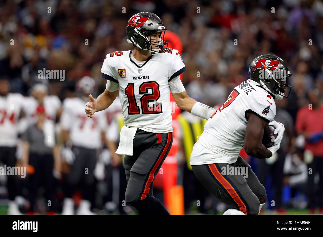 Tampa Bay Buccaneers quarterback Tom Brady (12) hands the ball to ...