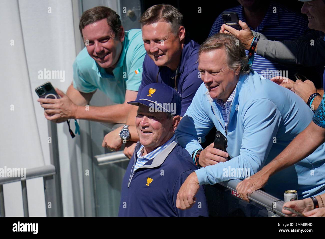 Former President George W. Bush poses for a photo with fans during a ...