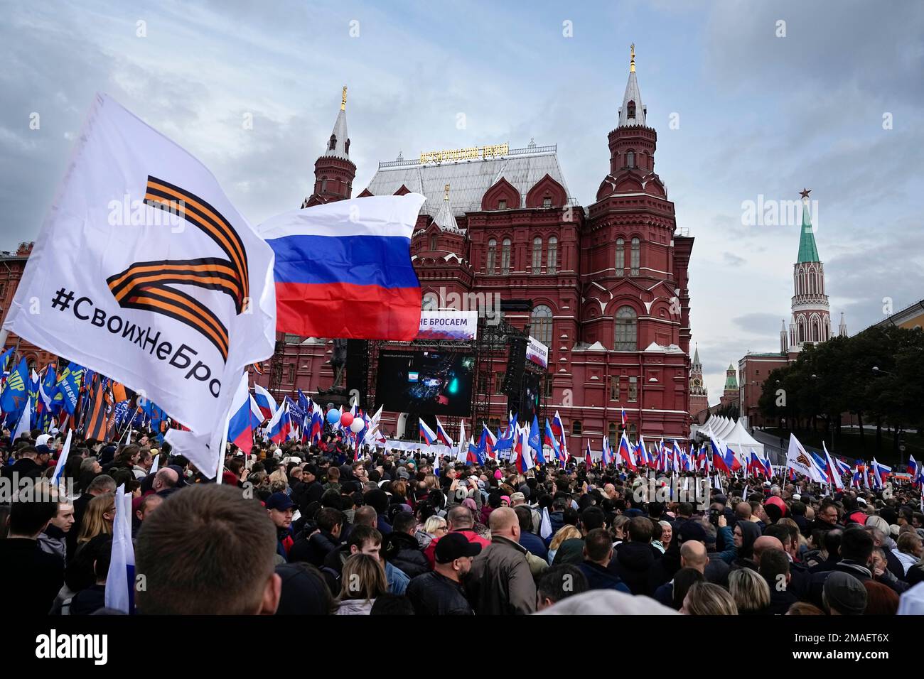Demonstrators hold Russian state flags and flags with with the letter Z ...