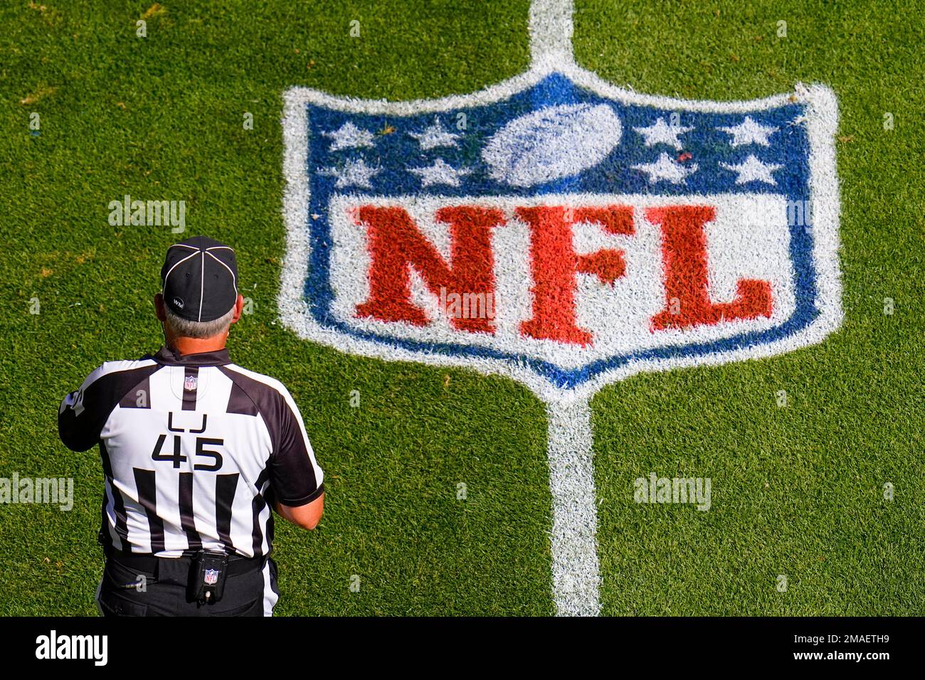 Line judge Jeff Seeman (45) looks on next to the NFL logo during an NFL ...