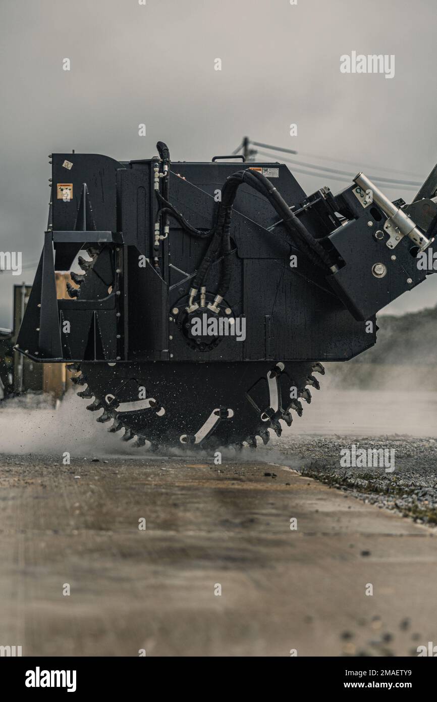 U.S. Sailors with Naval Mobile Construction Battalion 3 operate a skid ...