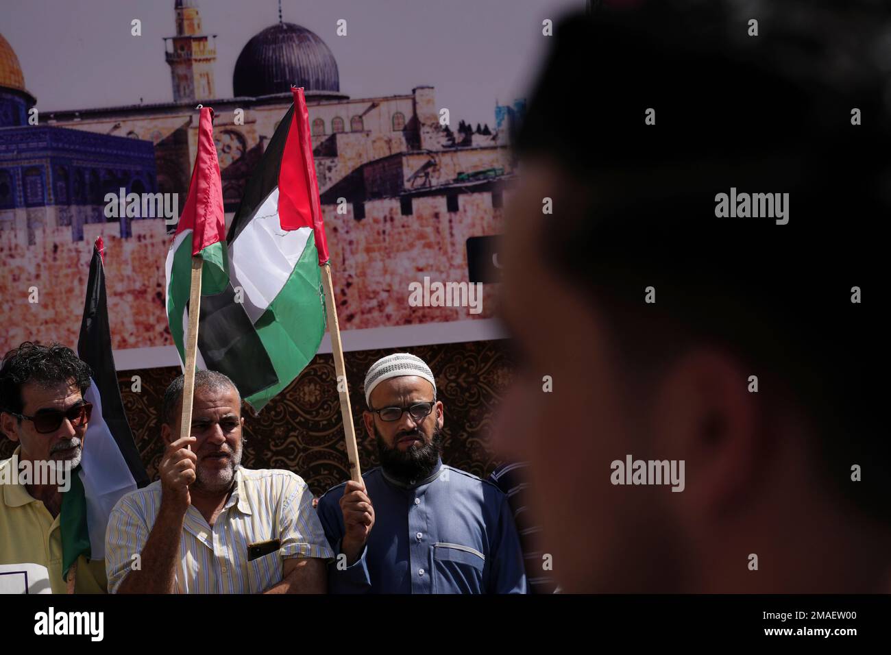 Palestinians wave their national flags during a rally organized by ...
