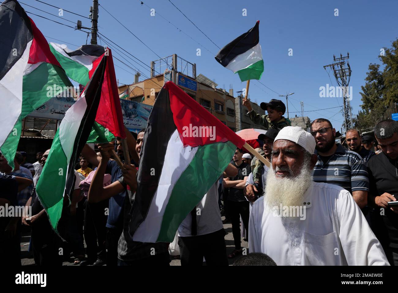 Palestinians wave their national flags during a rally organized by ...