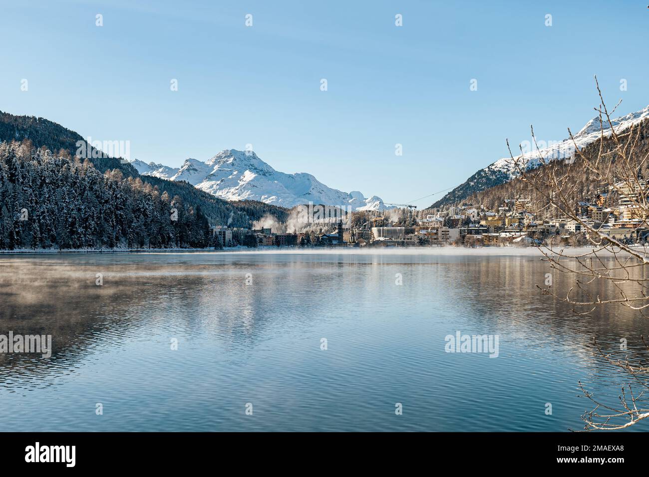 View of the town of St. Moritz and a lake, forest and mountains during ...
