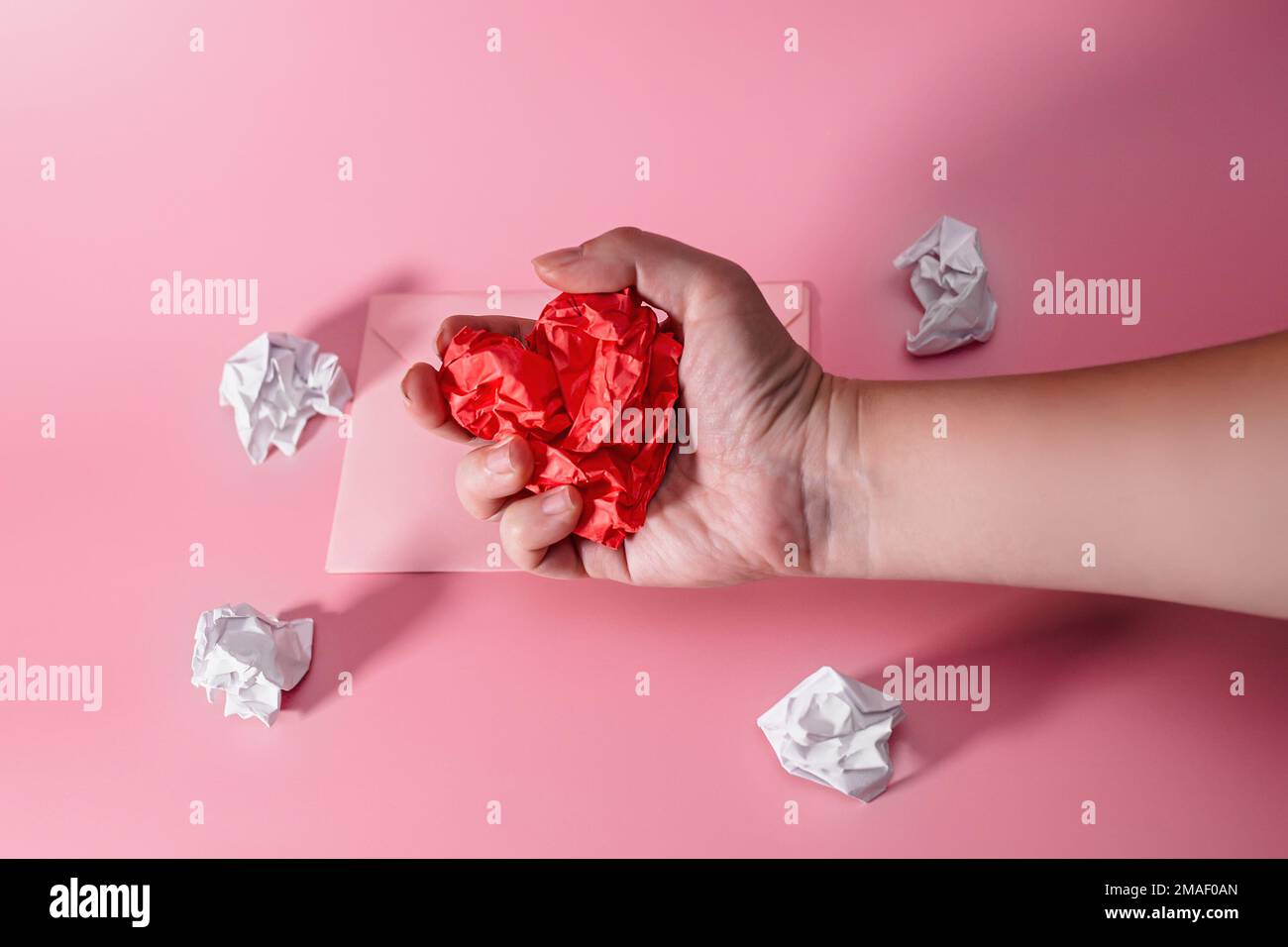 hand of aggressive and frustrated man squeezing heart out of crumpled ...