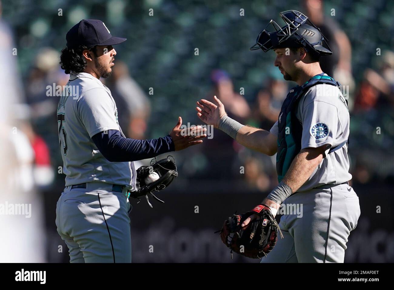 Seattle Mariners pitcher Andres Munoz, left, celebrates with catcher ...