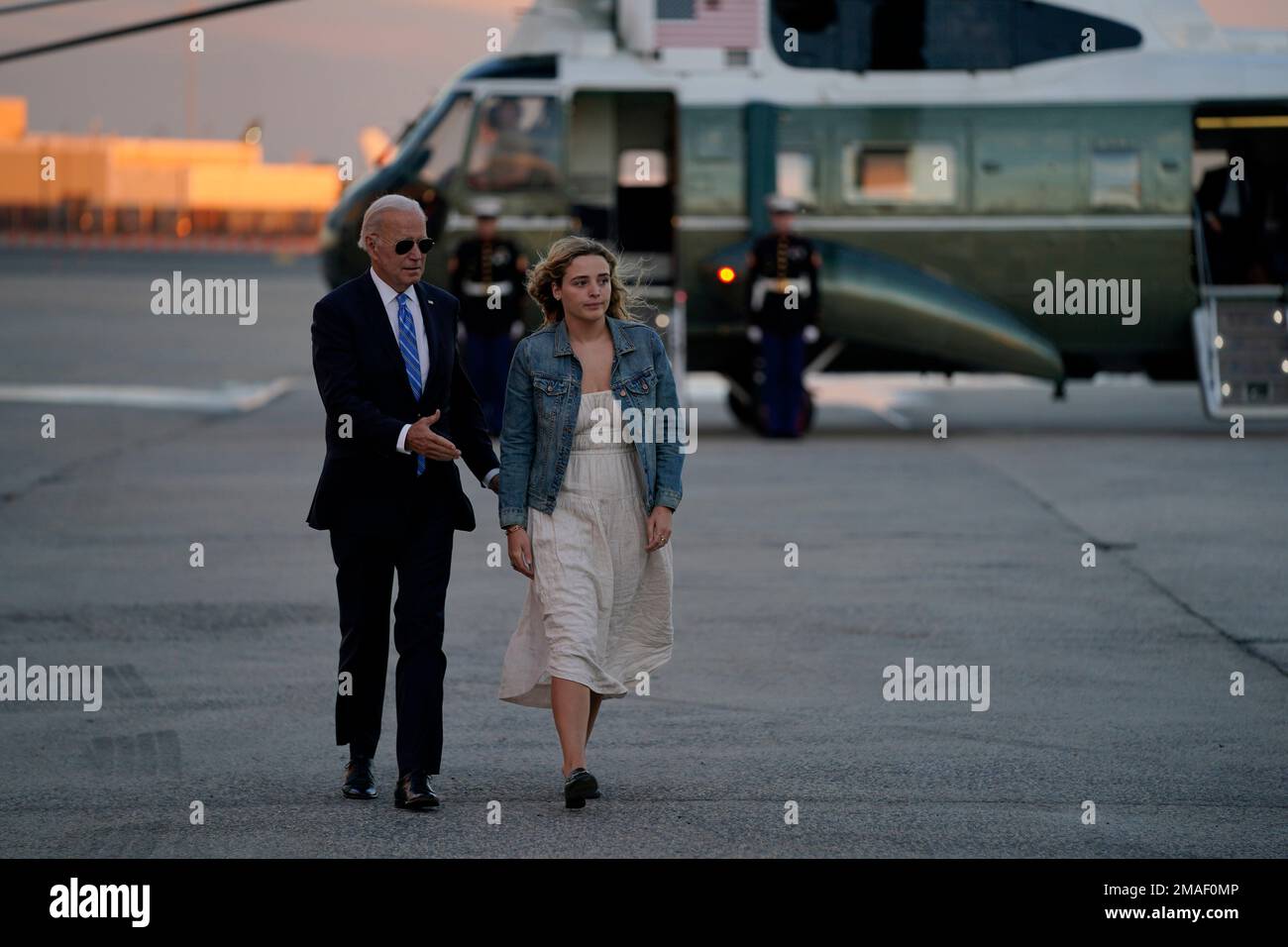 President Joe Biden walks with his granddaughter Finnegan Biden to ...
