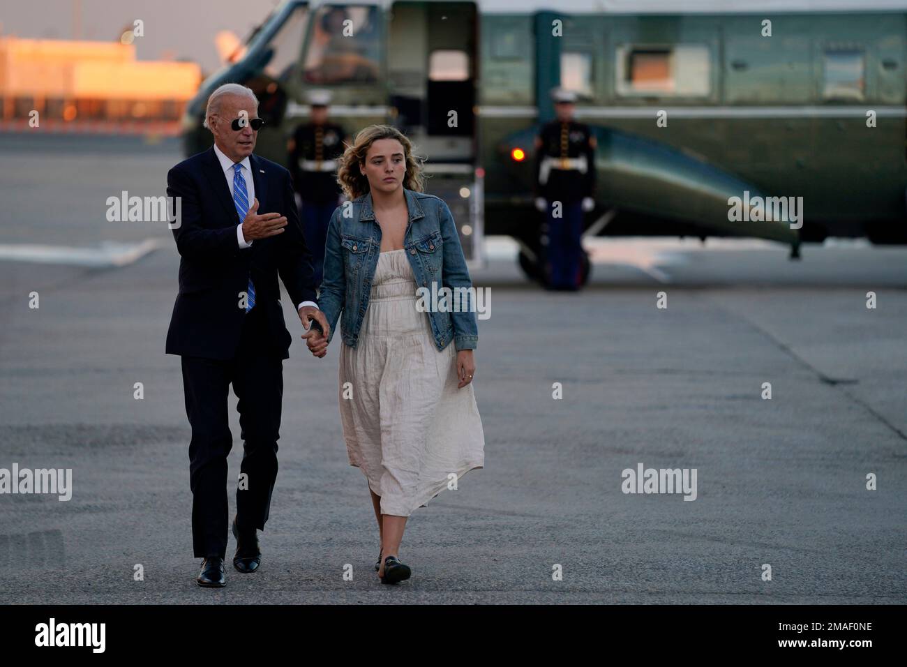 President Joe Biden walks with his granddaughter Finnegan Biden to ...