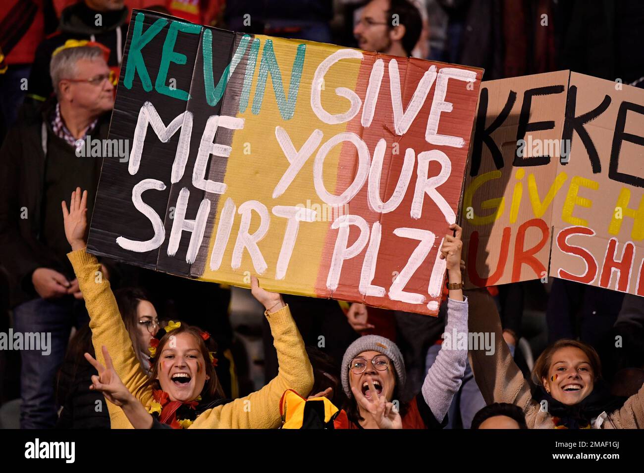 Fans hold up signs and cheer during the Nations League soccer match ...