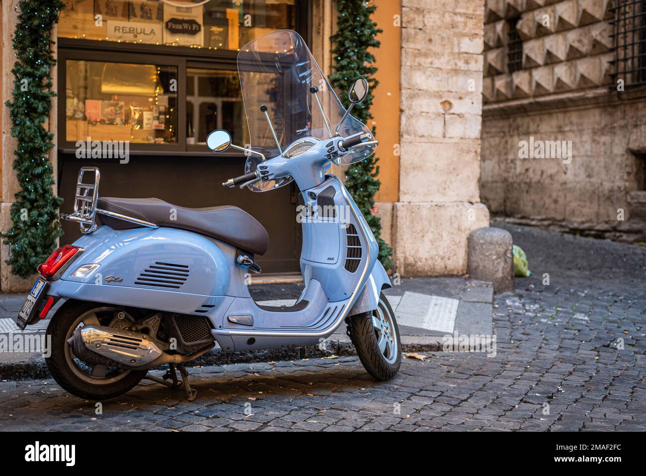 Blue Vespa Scooter On Cobblestones On Rome Street During Day Stock ...