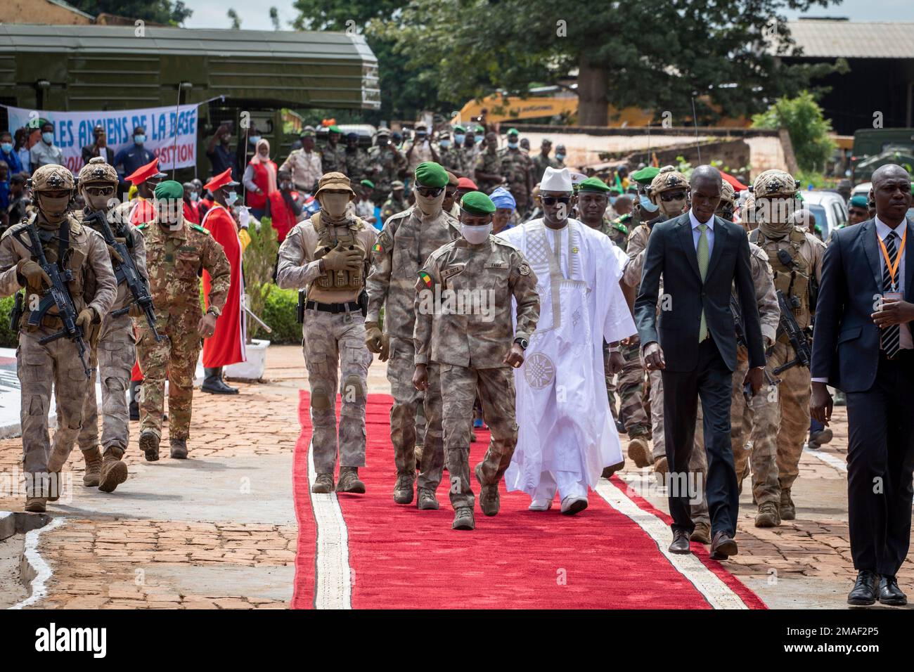Leader of Mali's ruling junta Lt. Col. Assimi Goita, center, walks with ...