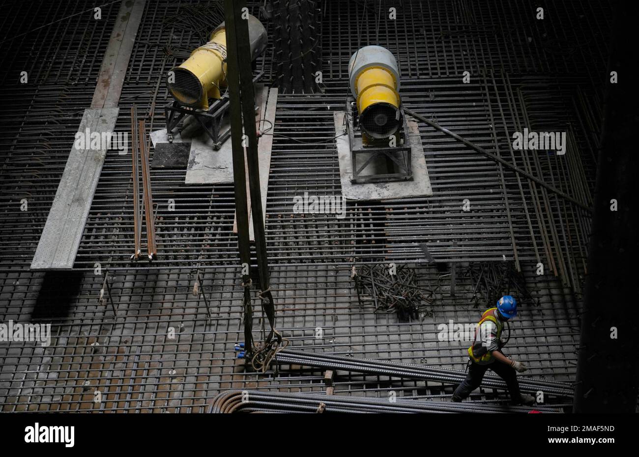 A worker walks inside a tunnel at a Mass Rapid Transit (MRT ...