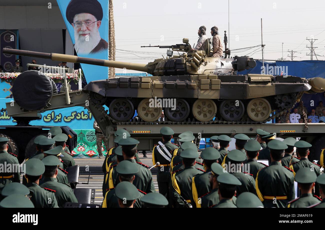 A tank of Iran's paramilitary Revolutionary Guard is driven past a ...