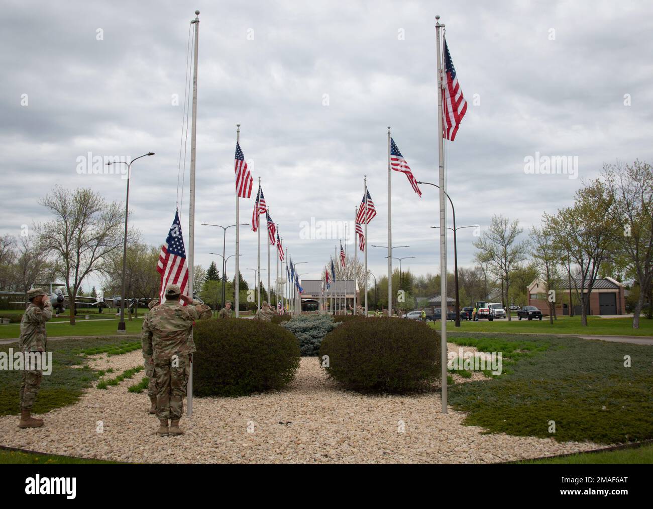 Airmen from the 319th Reconnaissance Wing raise the American flag on ...