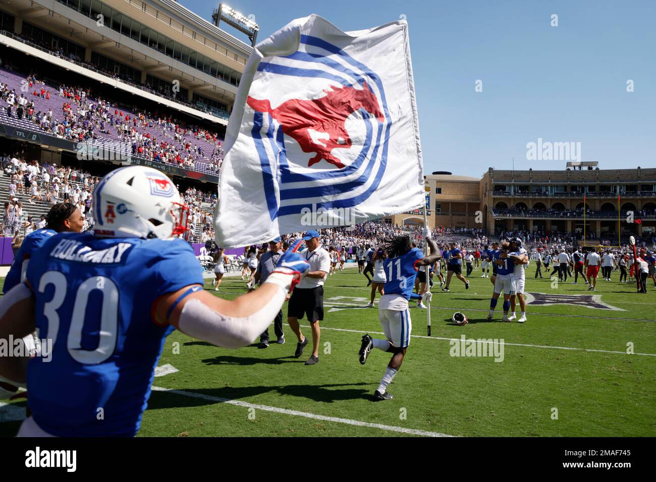 FILE - SMU wide receiver Rashee Rice (11), followed by linebacker Brian ...