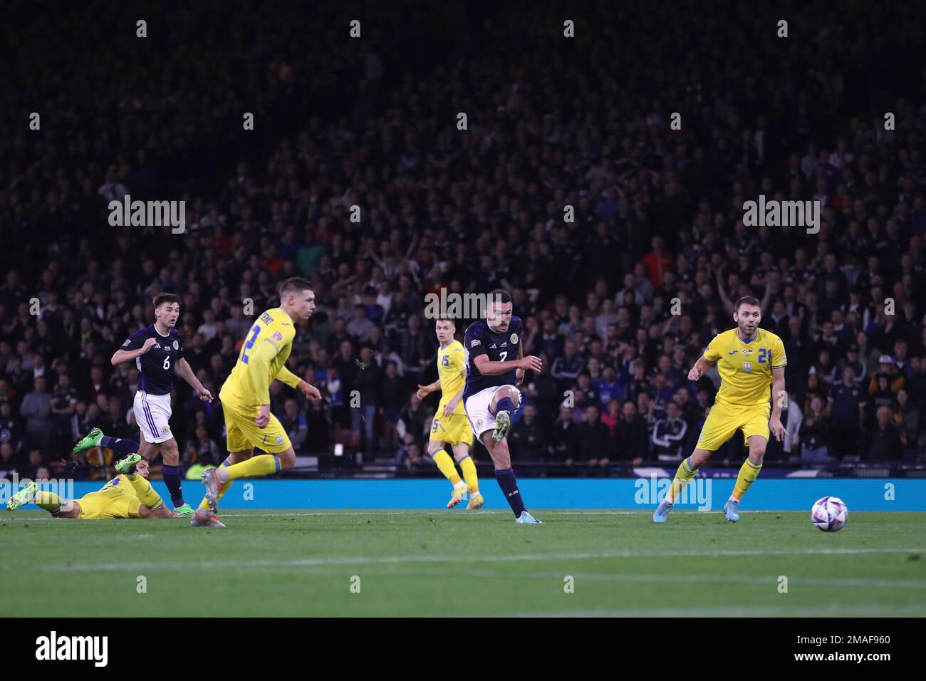 Scotland's John McGinn, second right, scores his side's opening goal during the UEFA Nations ...