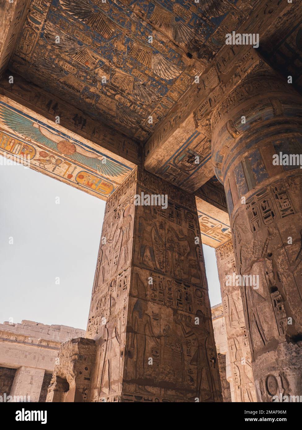 Colourful columns with hieroglyphs in Habu Temple, Luxor, Egypt Stock ...