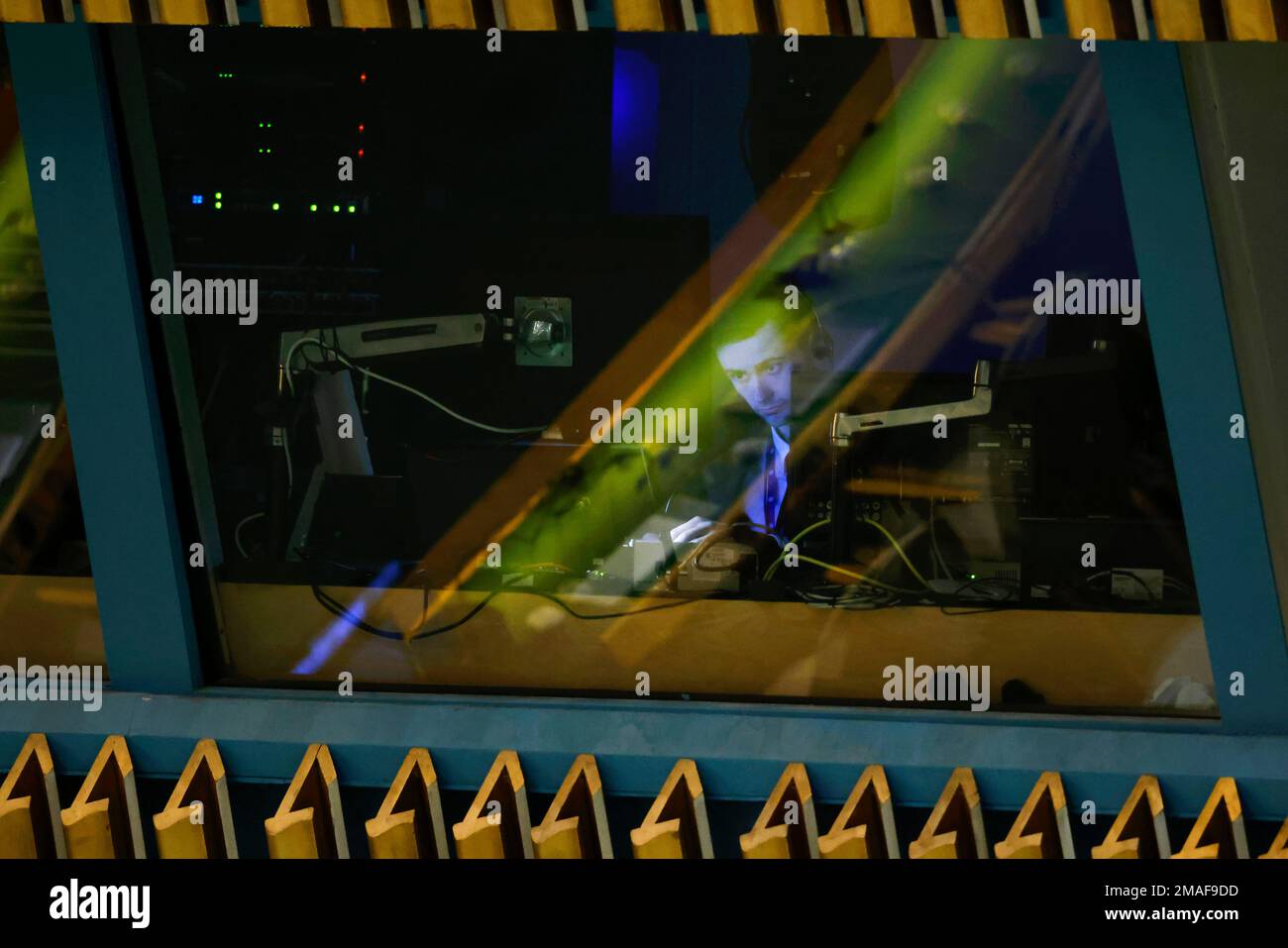 An individual works in an overhead booth during the 77th session of the ...