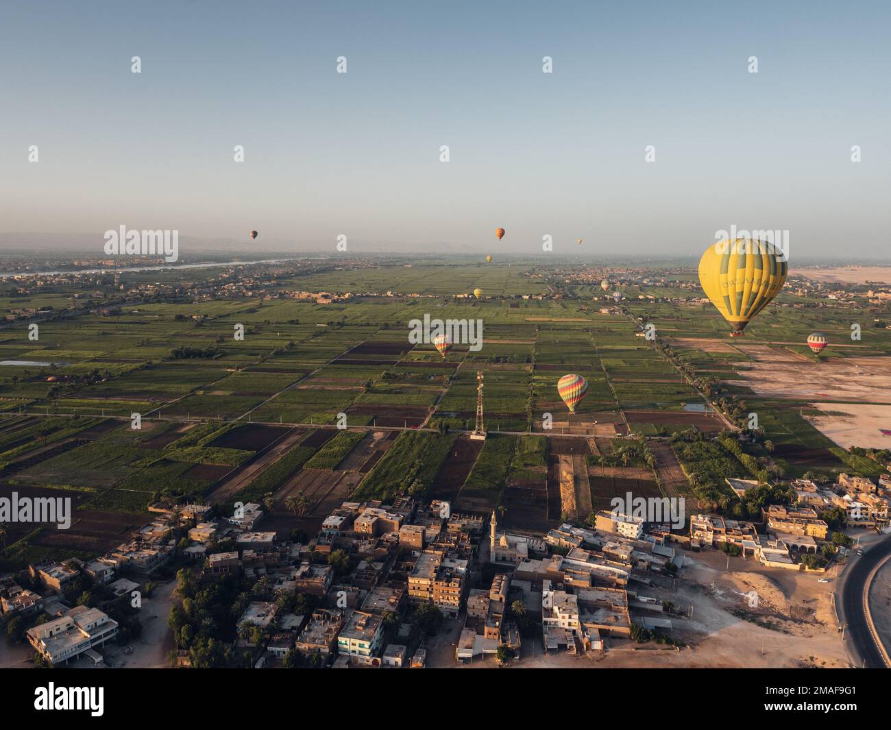 Aerial view of the agricultural fields and Luxor and balloons from a ...