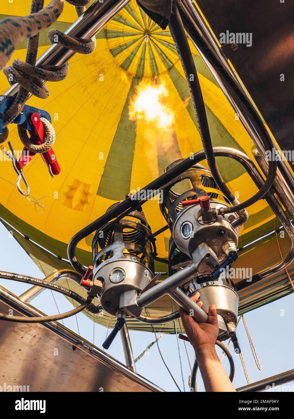 Hand of a man adding hot air to the inside of a balloon Stock Photo - Alamy