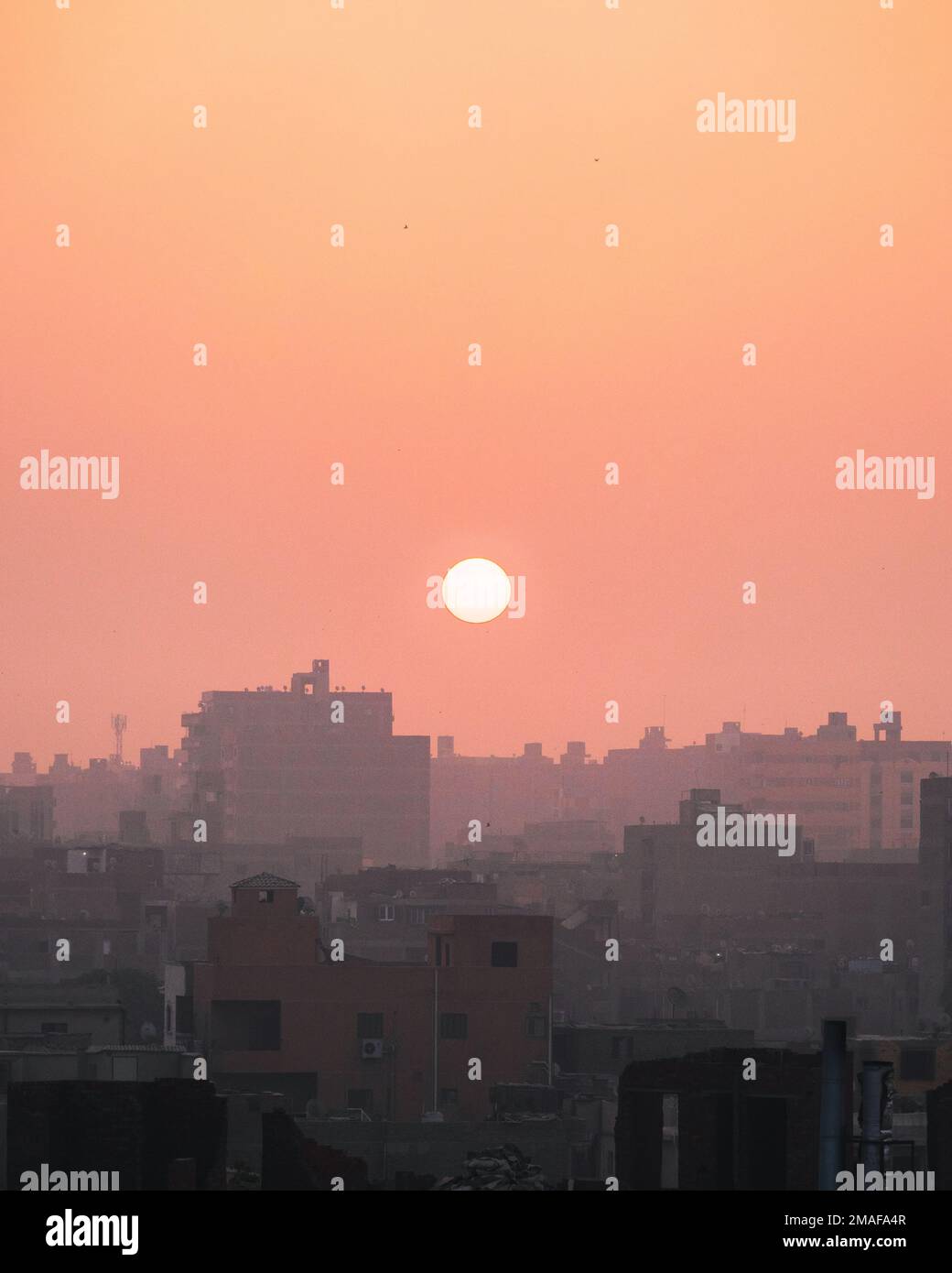 Sun rising over the buildings in Giza, Cairo, Egypt Stock Photo - Alamy