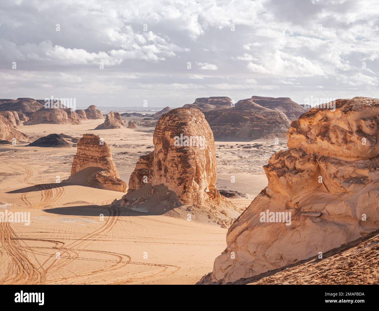 The view of car tracks and rocks in the sand of Valley of Agabat, White ...