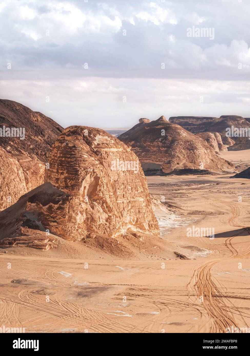 The view of car tracks and rocks in the sand of Valley of Agabat, White ...