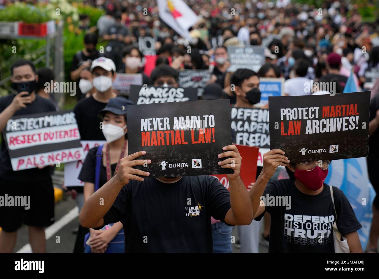 Activists hold slogans as they mark the 50th anniversary of martial law ...