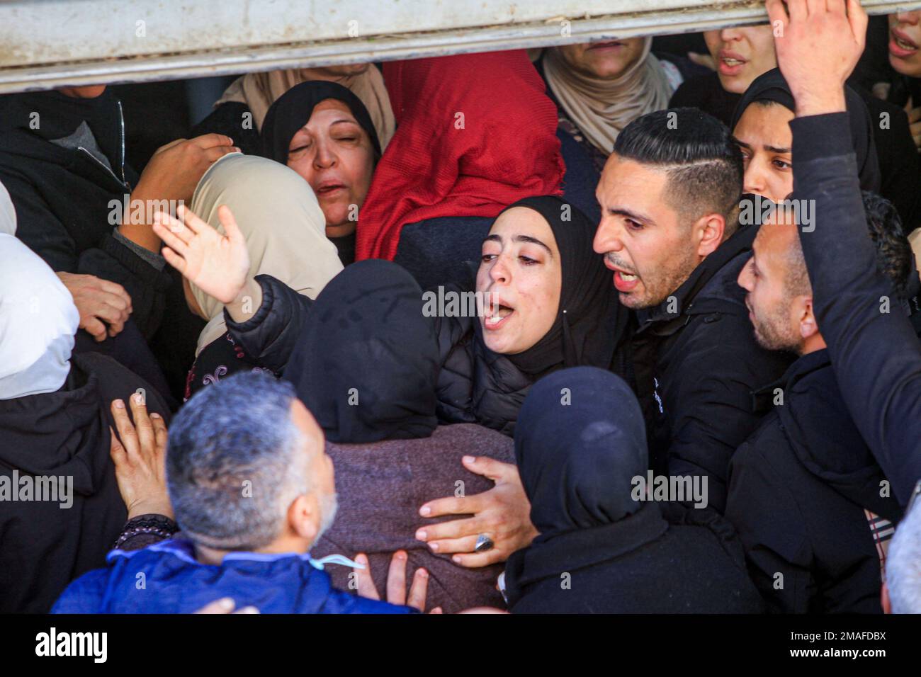 Jenin, Middle East. 19th Jan, 2023. Relatives mourn during the funeral ...