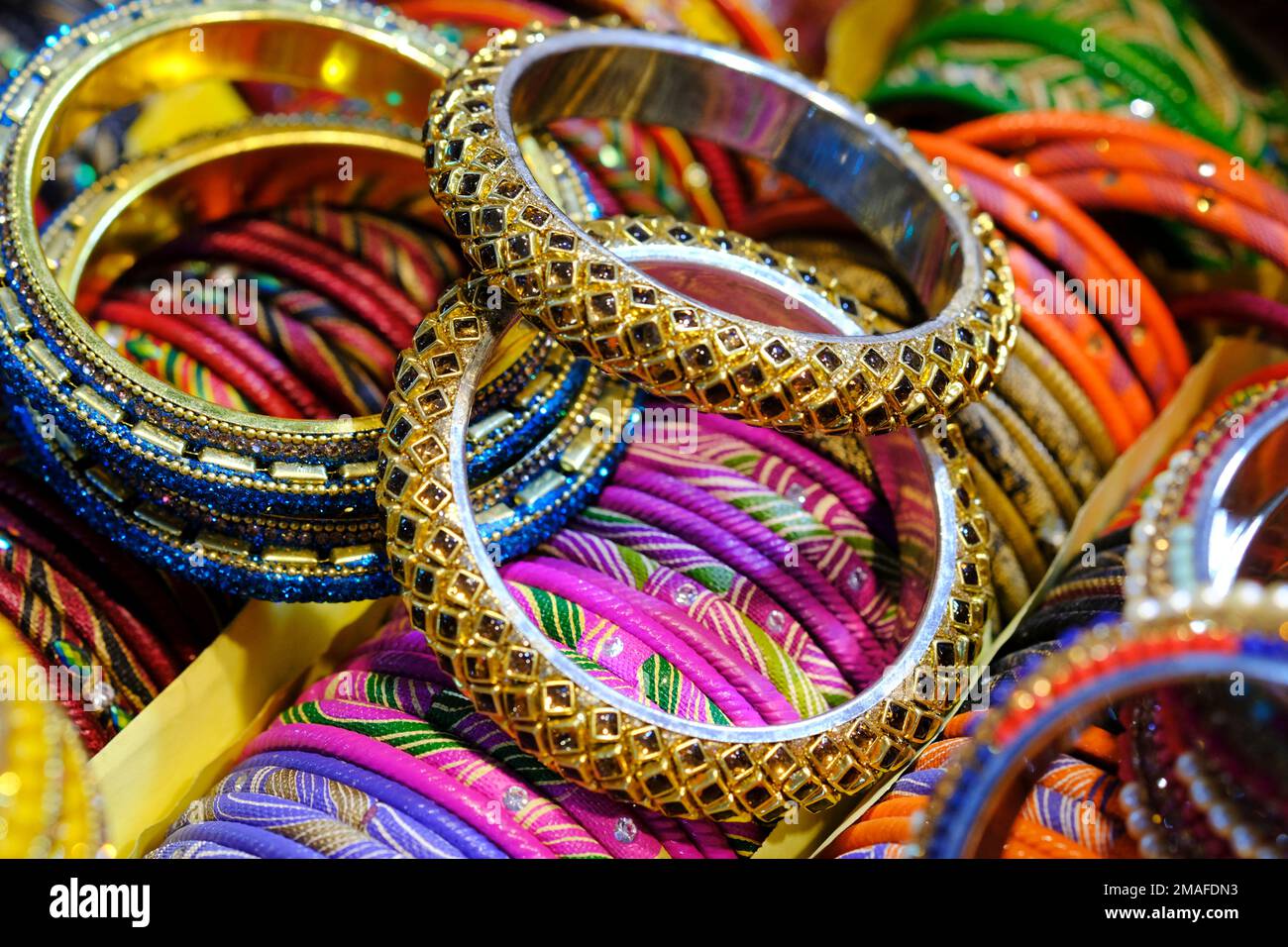 Indian Gold bangles displayed in local shop in a market of Pune, India ...
