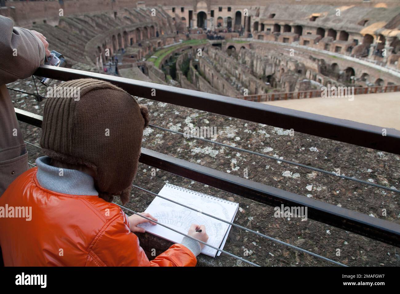 A young child draws a sketch of the inside of the Colloseum Stock Photo ...