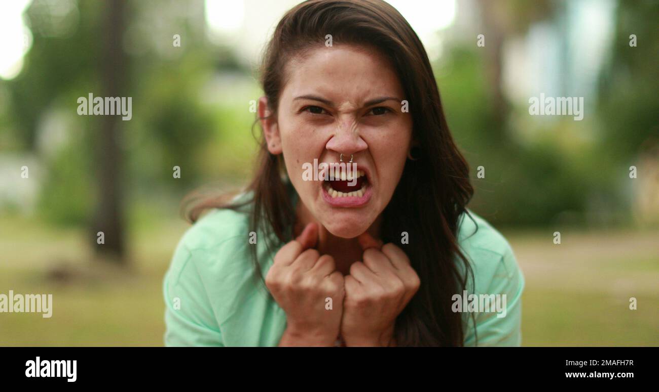 Angry young woman screaming from the top of her lungs feeling ...