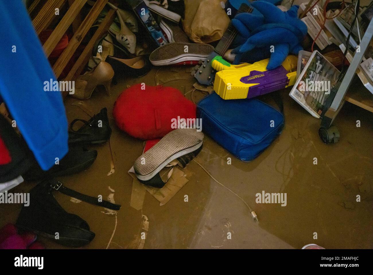 Shoes, video games, toys, stuffed animals and other belongings lay ...