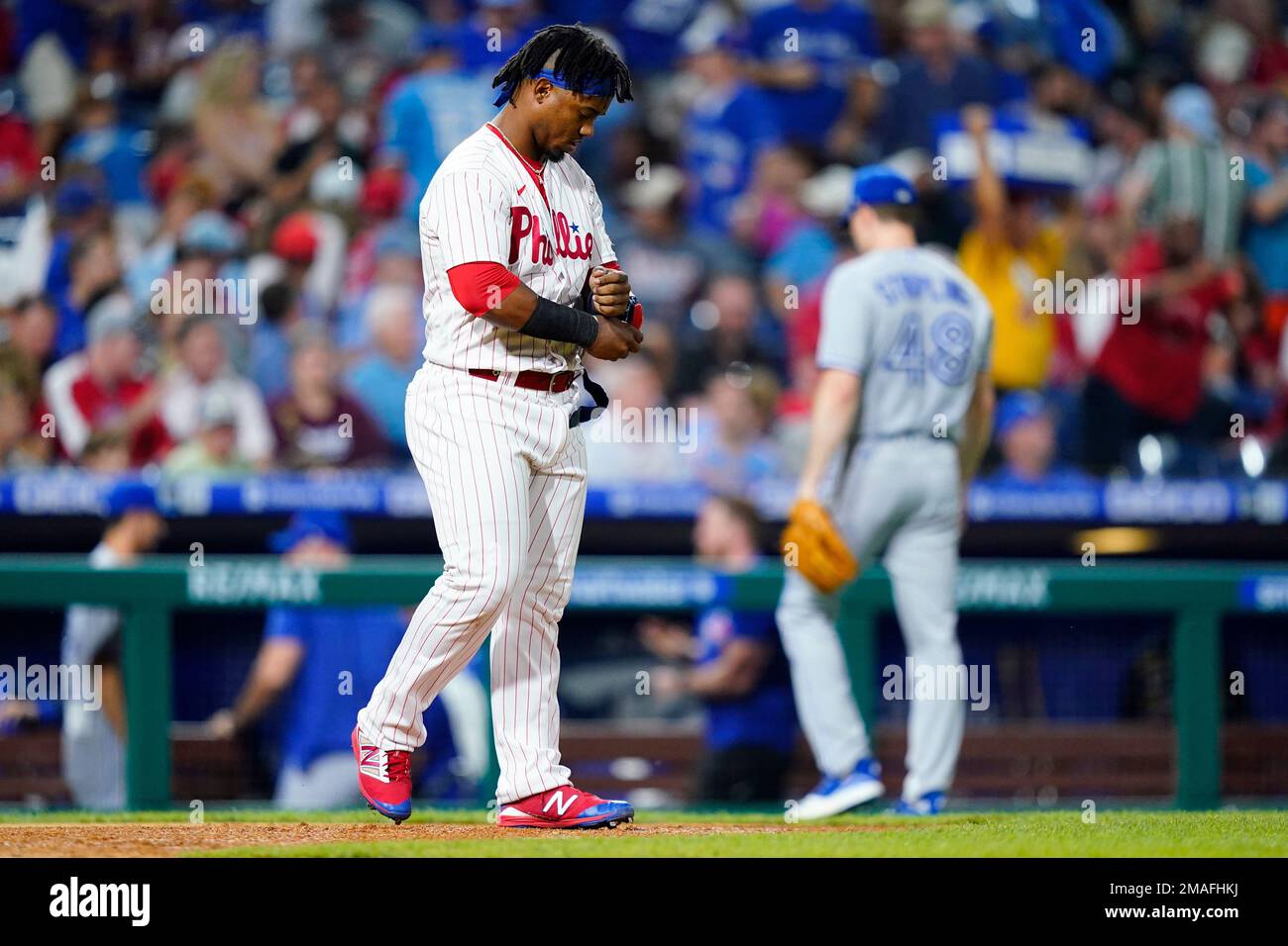 Philadelphia Phillies' Jean Segura, left reacts after striking out ...